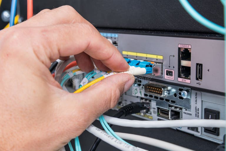 Hand of Computer Engineer Connecting Fiber Optic Cable in Server Stock ...