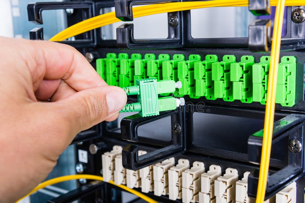 Hand of Computer Engineer Connecting Fiber Optic Cable in Server Stock ...