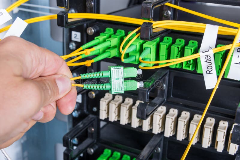Hand of Computer Engineer Connecting Fiber Optic Cable in Server Stock ...