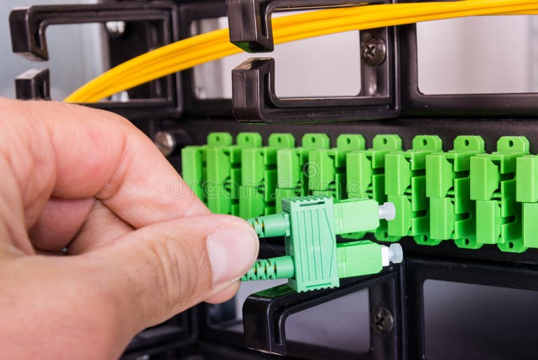Hand of Computer Engineer Connecting Fiber Optic Cable in Server Stock ...