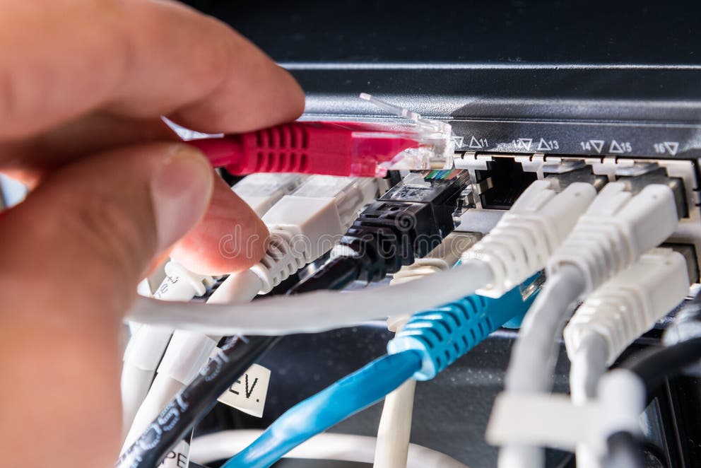 Hand of Computer Engineer Connecting Fiber Optic Cable in Server Stock ...