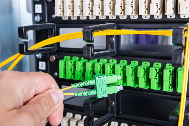 Hand of Computer Engineer Connecting Fiber Optic Cable in Server Stock ...