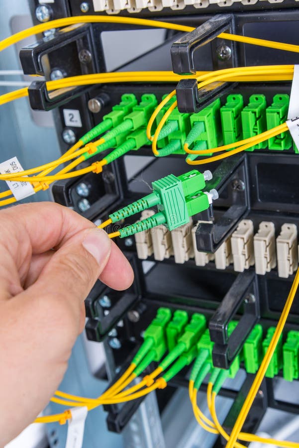 Hand of Computer Engineer Connecting Fiber Optic Cable in Server Stock ...