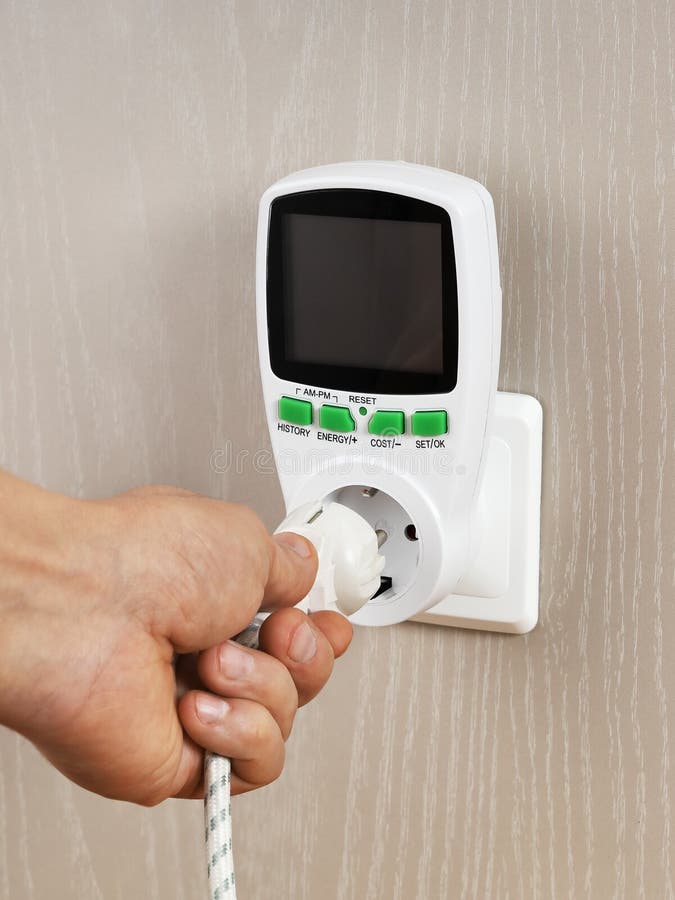 Hand Connects Plug with Wattmeter Socket on Wall, for Measuring ...