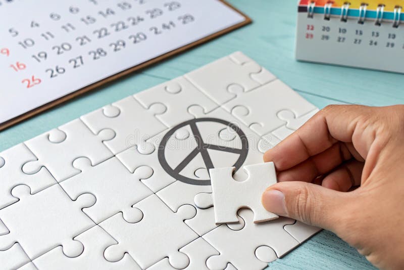 Hand Connects Puzzles of Sign of Peace. World Day of Peace Stock ...