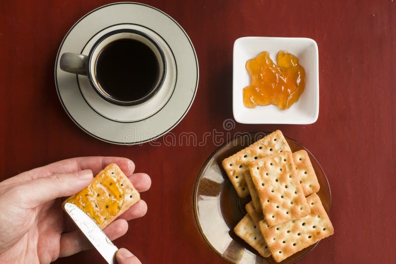 A Hand with a Cookie, Jar and Coffee . Breakfast Scene Stock Photo ...