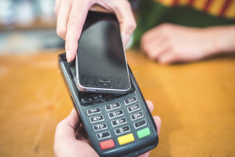 Hand of Customer Paying with Contactless by Mobile Device. Payment with ...