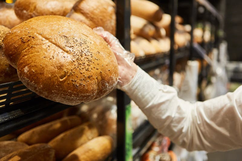 Hand of a Customer Takes Loaf of Bread from the Shelf Stock Image ...