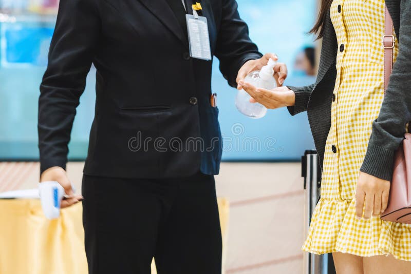 Hand of Customer Waits for a Drop of Alcohol Gel from Female Security ...