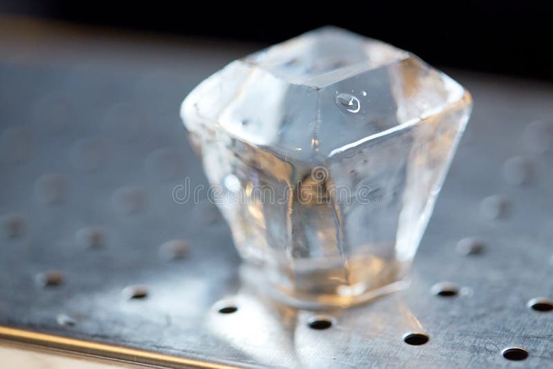 Hand-cut ice cube at bar stock photo. Image of concept - 92249348