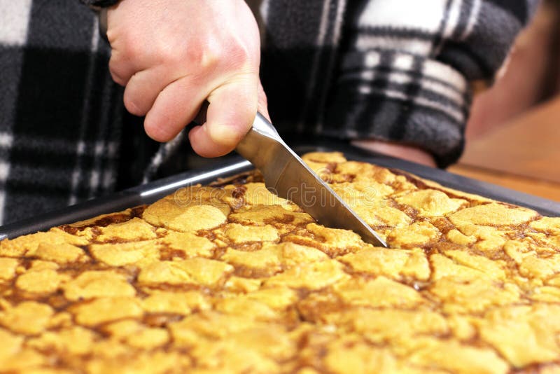 The Hand is Cutting the Cake. Cake on a Baking Sheet Stock Image ...
