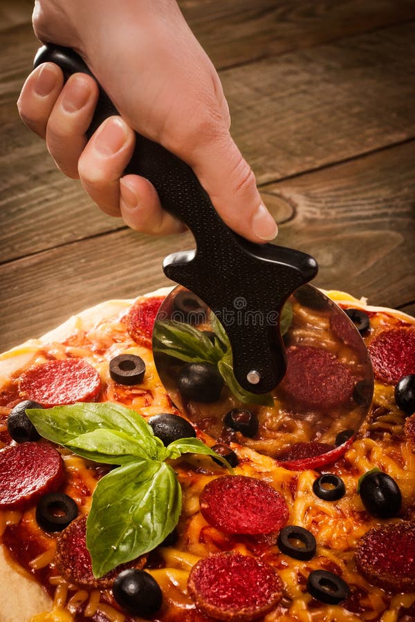 Hand Cutting Pepperoni Pizza Stock Photo - Image of cuttlery, cuisine ...