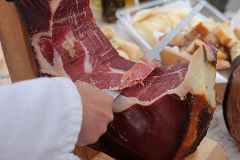 A hand cutting prosciutto stock photo. Image of delicatessen - 16665950