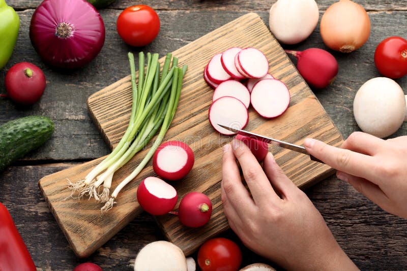 Hand cutting radishes stock image. Image of cutting - 112073369