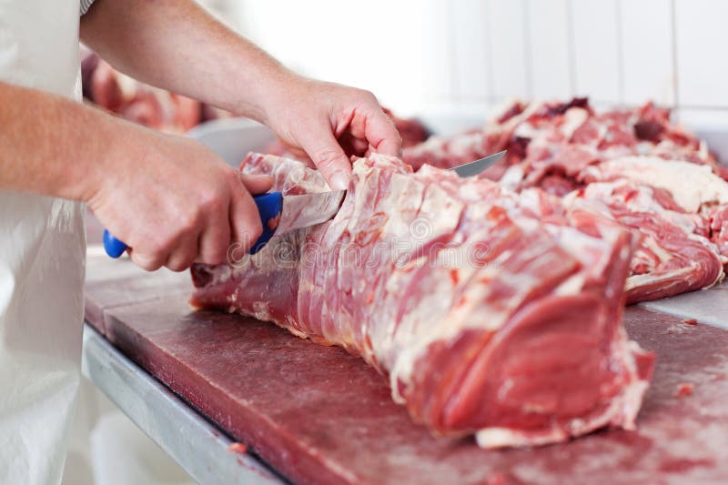 A hand cutting raw meat stock image. Image of slaughterhouse - 31303169