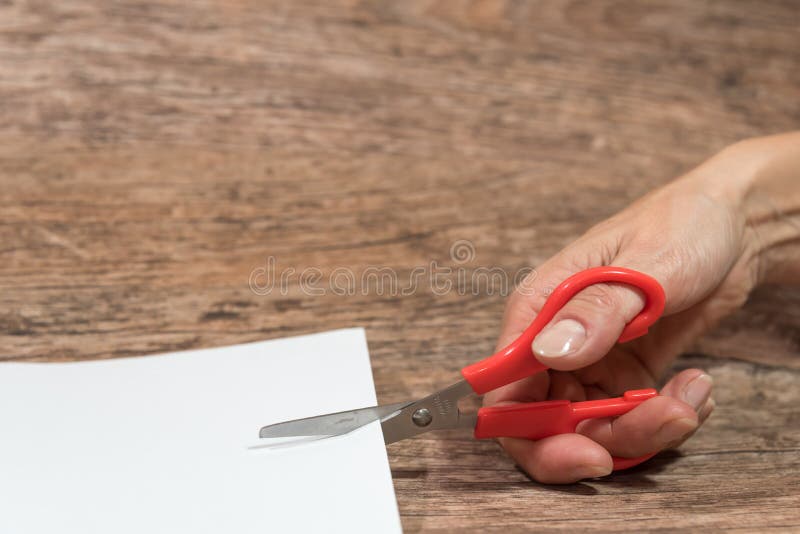 Hand Cutting a Sheet of Paper with Scissors Stock Image - Image of ...