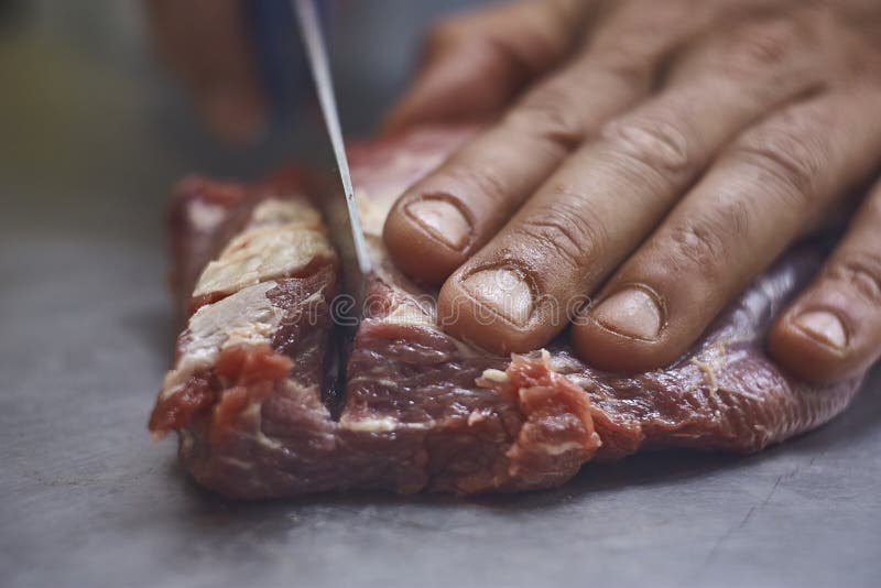 Hand cutting steak stock photo. Image of hand, butchering - 102014764