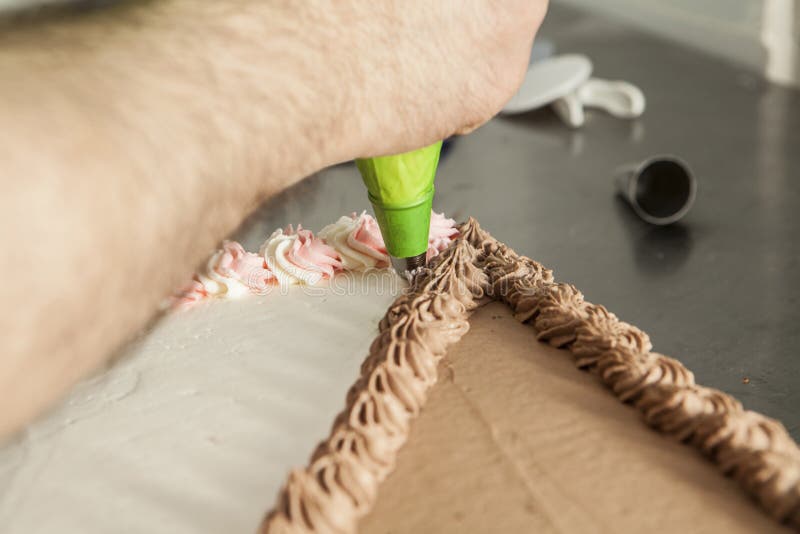 Hand Decorating Cake stock photo. Image of gourmet, ornate - 69130534