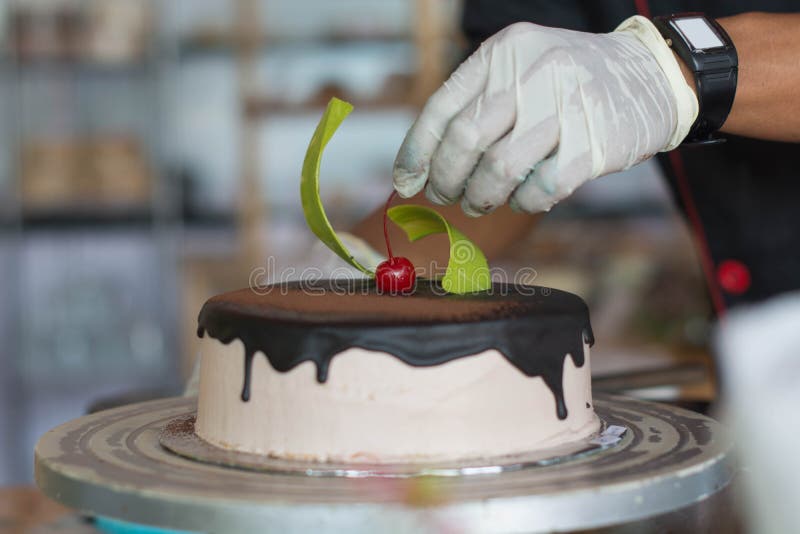 Hand decorating cake stock photo. Image of green, bundt - 148794982