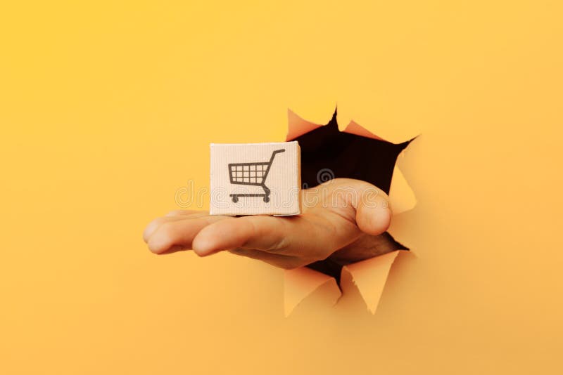 Hand with a Delivery Box through a Yellow Paper Hole Stock Photo ...