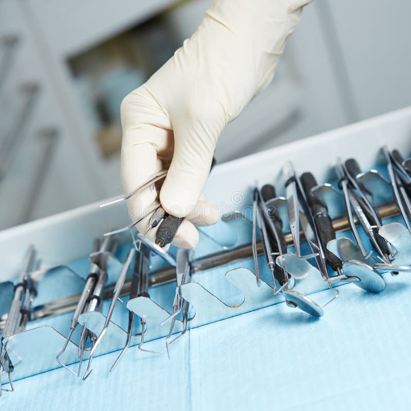 Hand of Dentist Reaching for Dental Instruments Stock Photo - Image of ...