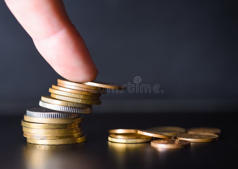 Hand Destroys a Tower of Coins on a Black Background Stock Image ...