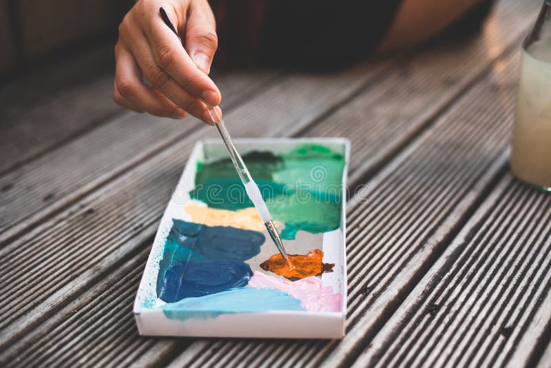 Hand Dipping a Brush into a Paint Palette Stock Image - Image of hand ...