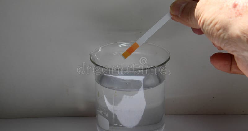 Hand Dips a Test Strip into a Solution in a Beaker Stock Image - Image ...
