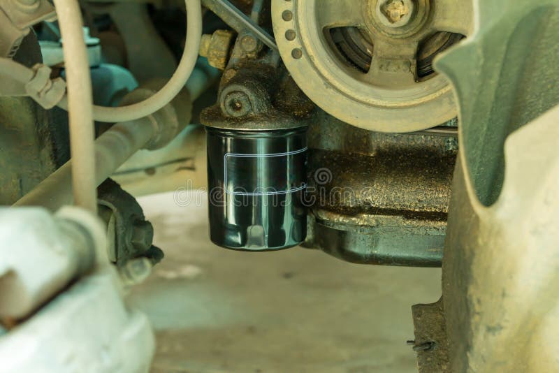 Hand are Disassembled Oil Filter Under the Car Engine. Stock Photo ...