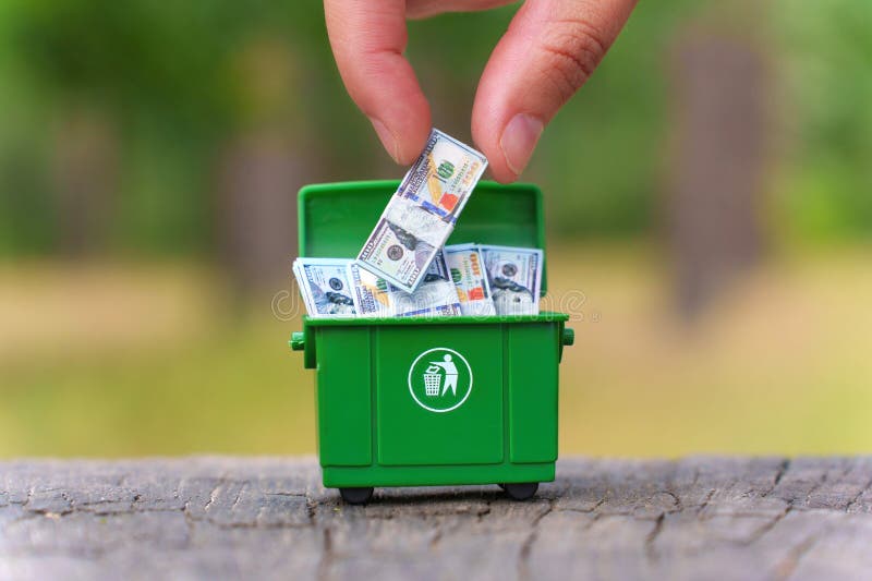 Hand Disposing Cash into a Green Trash Container Stock Image - Image of ...