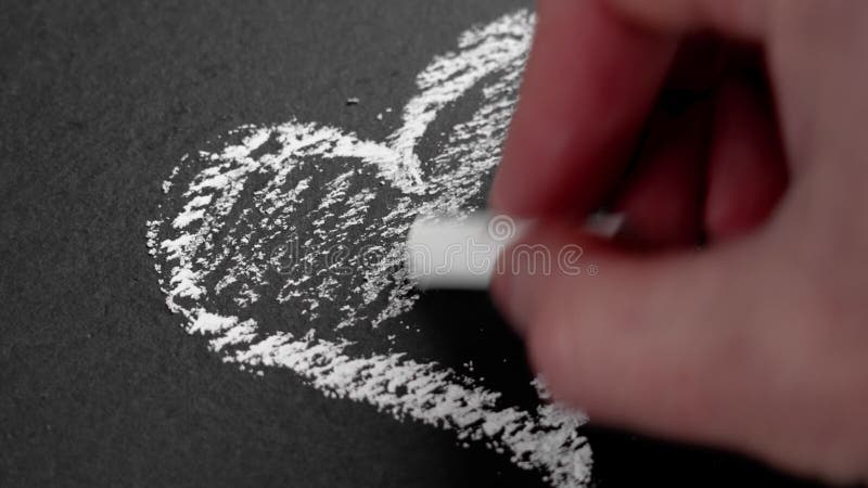 A Hand Drawing a Heart in Chalk and Hatching a Romantic Symbol on a ...