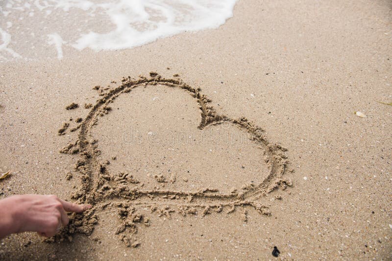 Hand Drawing Heart Shape on Sand Stock Photo - Image of ocean ...