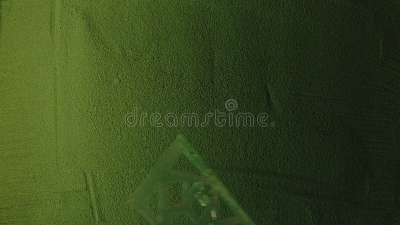Hand Drawing the Yin and Yang Symbol in the Green Sand and Then Erases ... Hand Drawing the Yin and Yang Symbol in the Green Sand and Then Erases ...