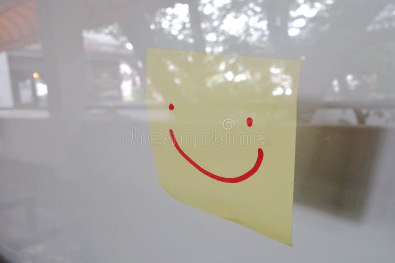 Hand Drawn Smiley Face on Sticky Note on Glass Wall Stock Photo - Image ...
