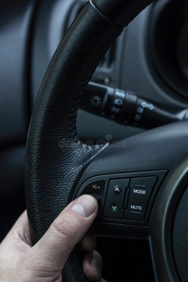 Hand of Driver on Steering Wheel Adjusts Audio Volume Control Stock ...