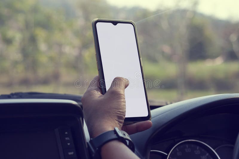 Hand of Driver is Using a Mobile Phone To Help Navigate or GPS while ...