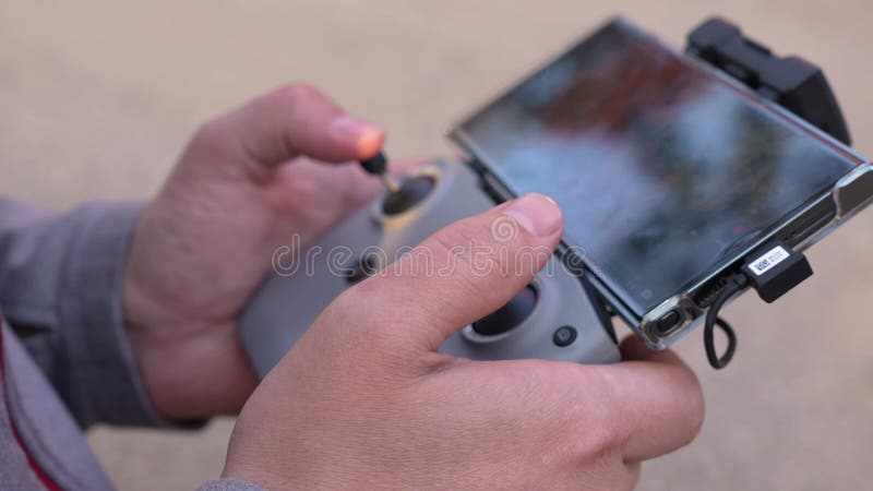 Hand of a Drone Operator Man Closeup while Pilot a Quadcopter Remote ...