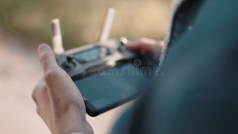 Hand of a Drone Operator Man while Pilot a Quadcopter Remote Controller ...