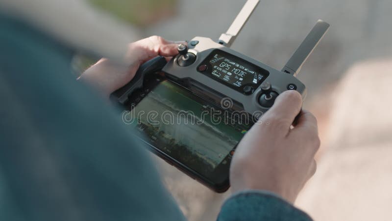 Hand of a Drone Operator Man while Pilot a Quadcopter Remote Controller ...