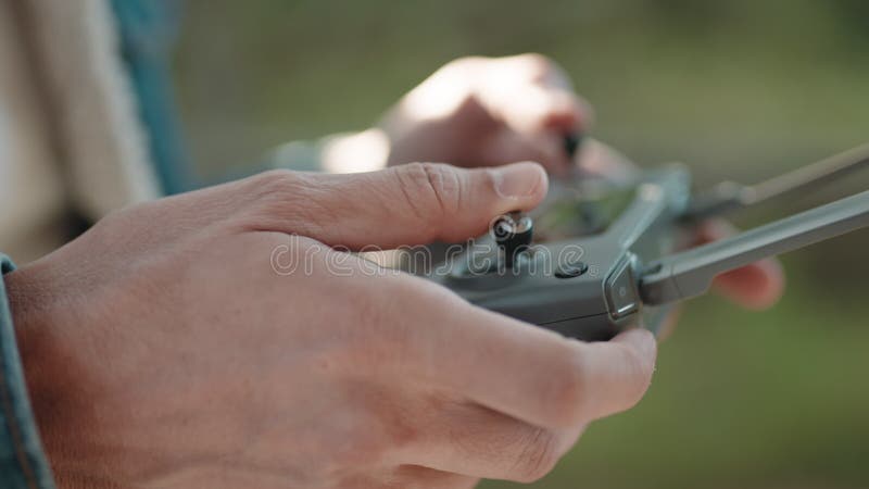 Hand of a Drone Operator Man while Pilot a Quadcopter Remote Controller ...