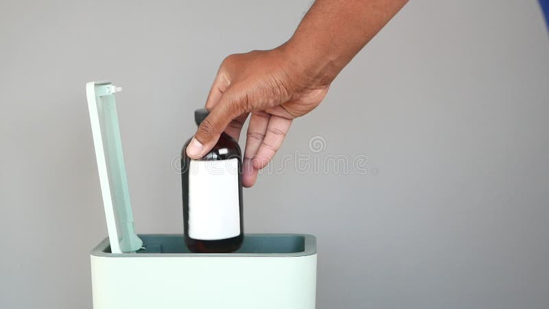 Proper Disposal of Empty Bottles in a Recycling Bin at Home Stock ...