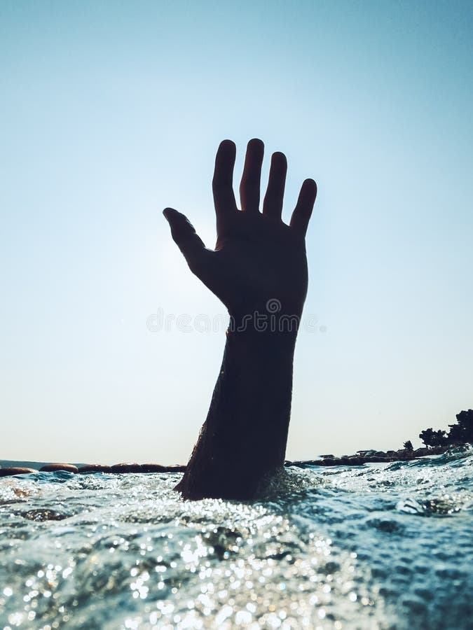 Hand of a Drowning Man Reaching Out from the Deep Cold Sea Water and ...