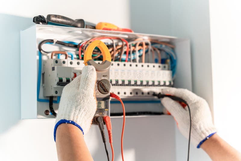 Hand of Electrician Engineer Tests Electrical Installations and Wires ...