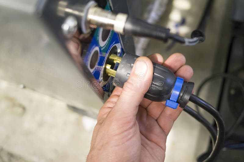 Hand of Electrician Inserts Plug into Socket Stock Photo - Image of ...