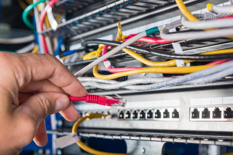 Hand of Engineer Plugging in Ethernet Cable into Server Switch P Stock ...