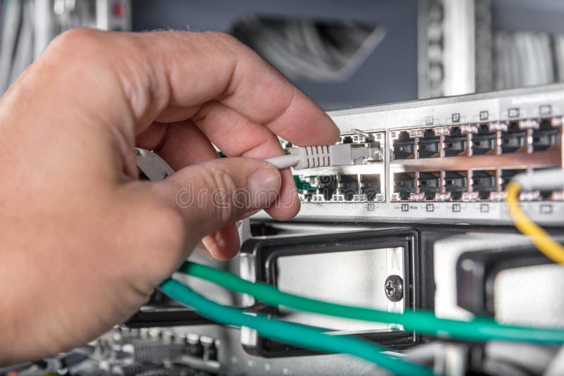 Hand of Engineer Plugging in Ethernet Cable into Server Switch P Stock ...