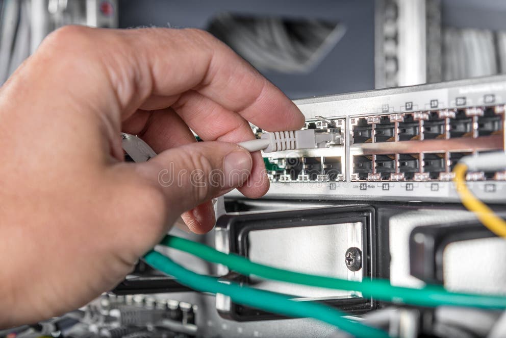 Hand of Engineer Plugging in Ethernet Cable into Server Switch P Stock ...