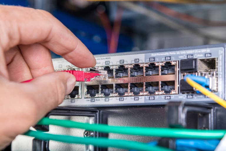 Hand of Engineer Plugging in Ethernet Cable into Server Switch P Stock ...