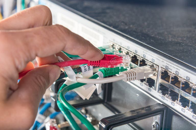 Hand of Engineer Plugging in Ethernet Cable into Server Switch P Stock ...