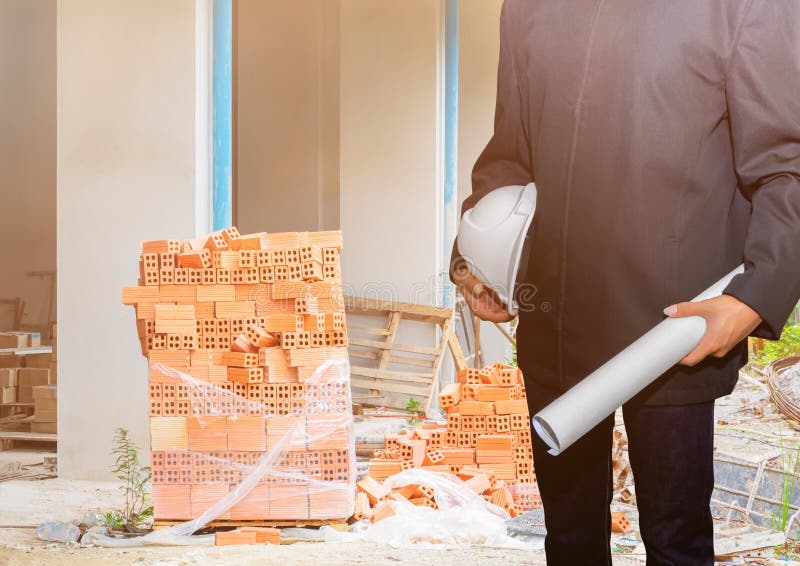 Hand of Engineering Holding Paper Plan Blueprint and Wear Helmet ...